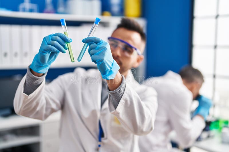Two Men Scientists Holding Test Tubes Using Microscope at Laboratory ...