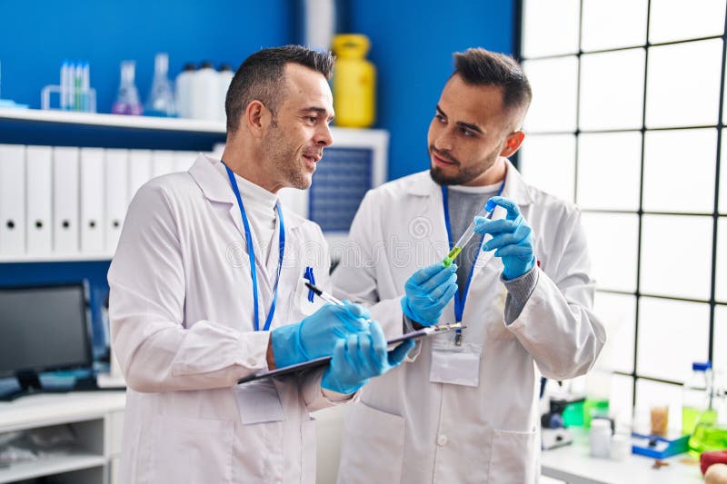 Two Men Scientists Writing on Document Holding Test Tube at Laboratory ...