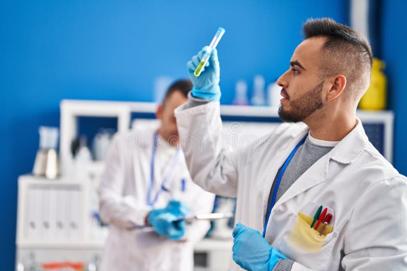 Two Men Scientists Writing on Document Holding Test Tube at Laboratory ...