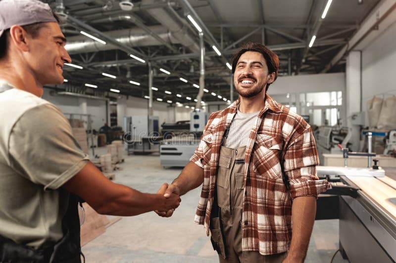 Two Men Shaking Hands on Background of Workshop Close Up Stock Photo ...