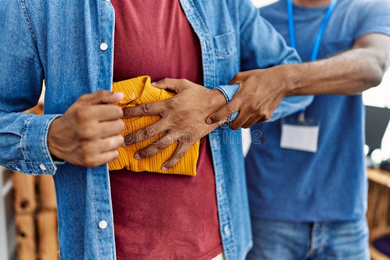 Two Men Shopkeeper and Customer Thief Stealing Clothes at Clothing ...