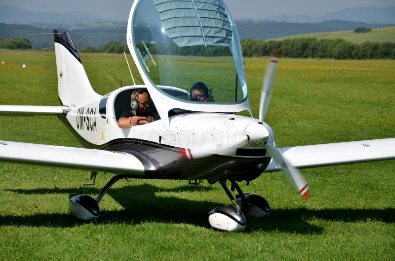 Two Men Sit into Ultralight Propeller-driven Airplane and Get Ready for ...