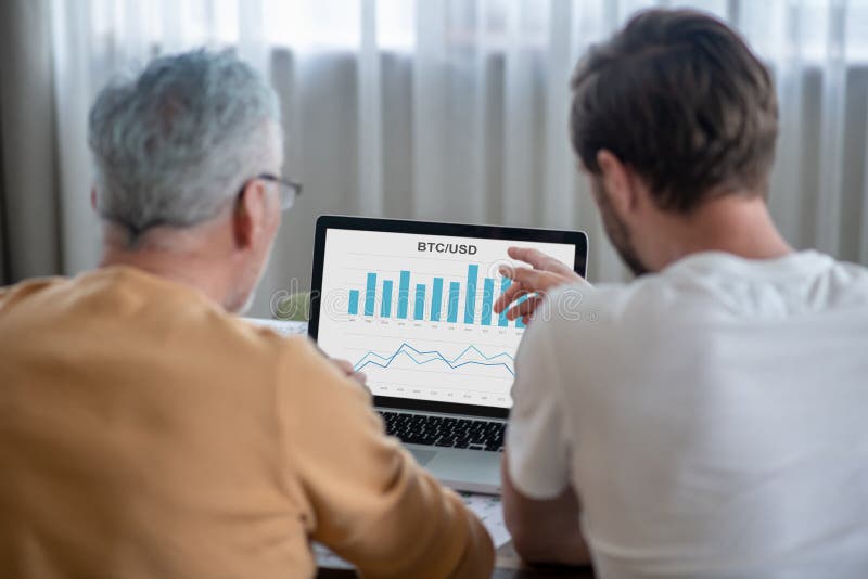 Two Men Sitting Nat the Table and Working on a Laptop Stock Image ...