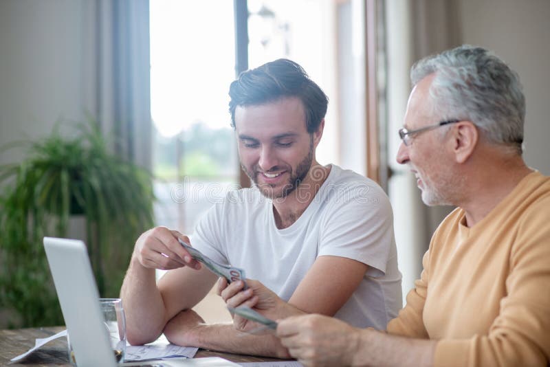 Two Men Sitting Nat the Table and Working on a Laptop Stock Image ...