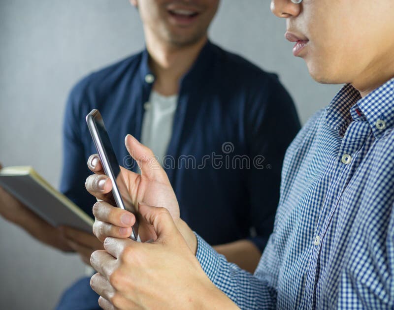 Two Men Sitting Together Using Phone and Study Talking Stock Photo ...