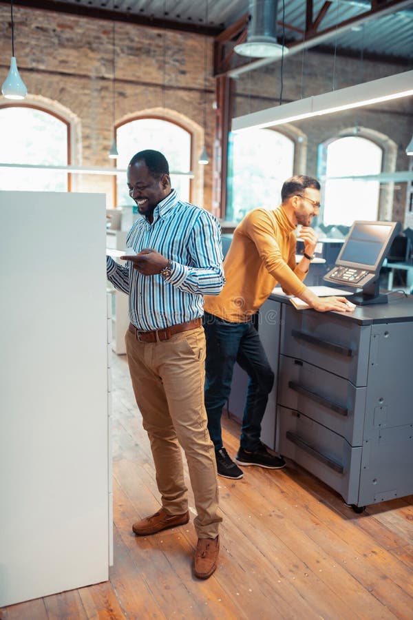 Two Men Smiling while Communicating in Publishing Office Stock Photo ...