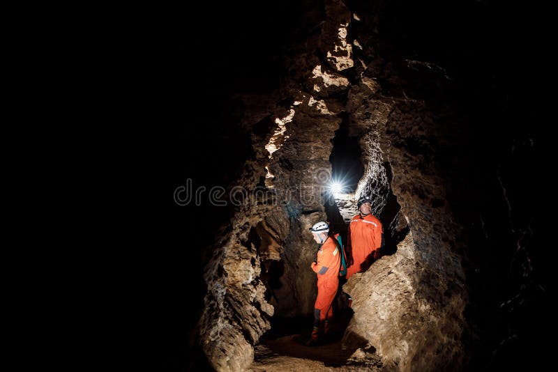 Two Men, Strong Physique, Explore the Cave. Men Dressed in Special ...