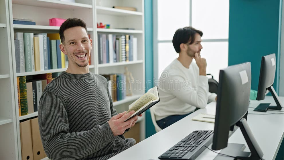 Two Men Students Using Computer Reading Book Studying at Library ...