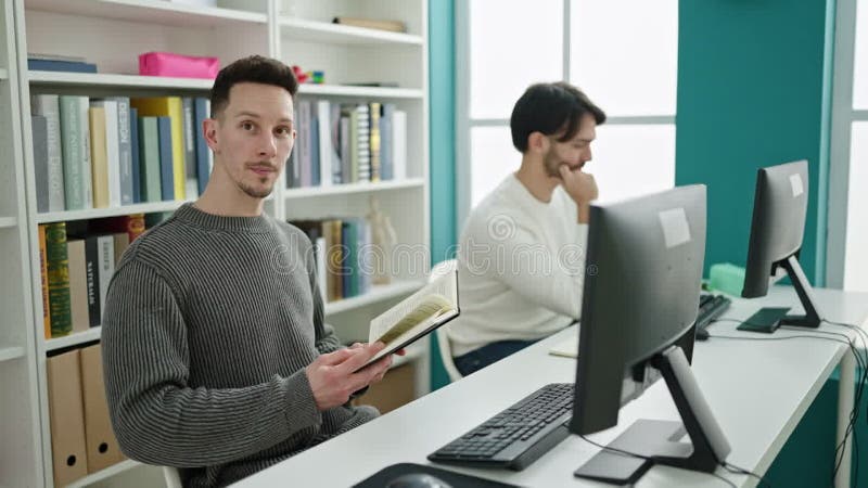 Two Men Students Using Computer Reading Book Studying at Library University Stock Video - Video ...