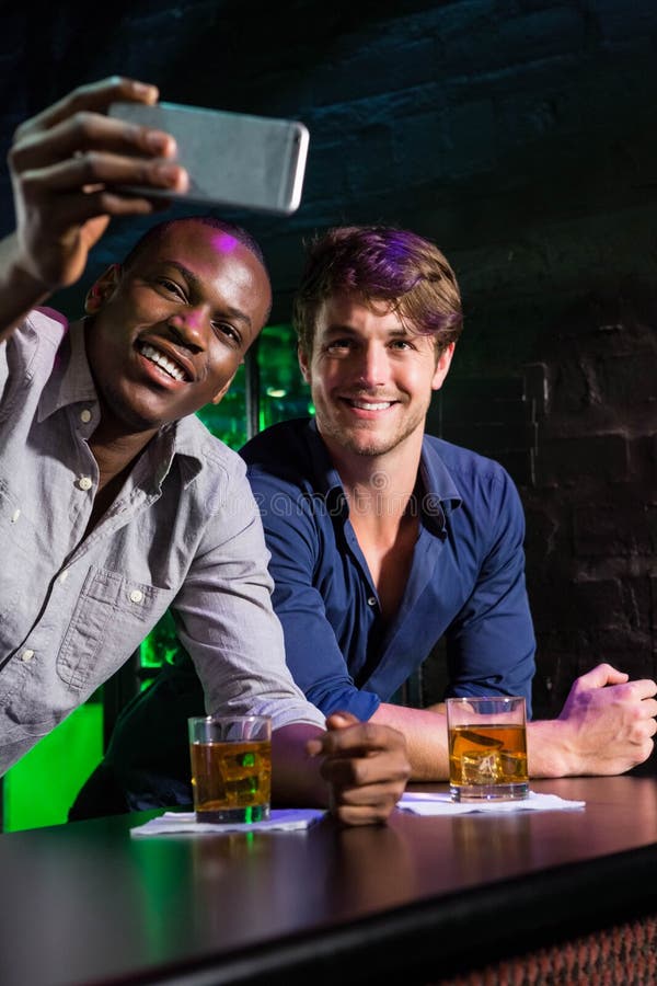 Two Men Taking a Selfie on Phone at Bar Counter Stock Image - Image of ...