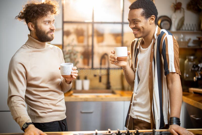 Two Men Talking and Drinking Coffee on Kitchen at Home Stock Photo ...