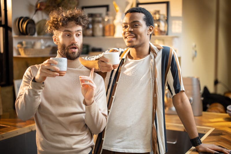Two Men Talking and Drinking Coffee on Kitchen at Home Stock Photo ...