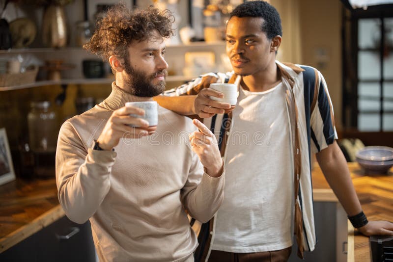 Two Men Talking and Drinking Coffee on Kitchen at Home Stock Photo ...