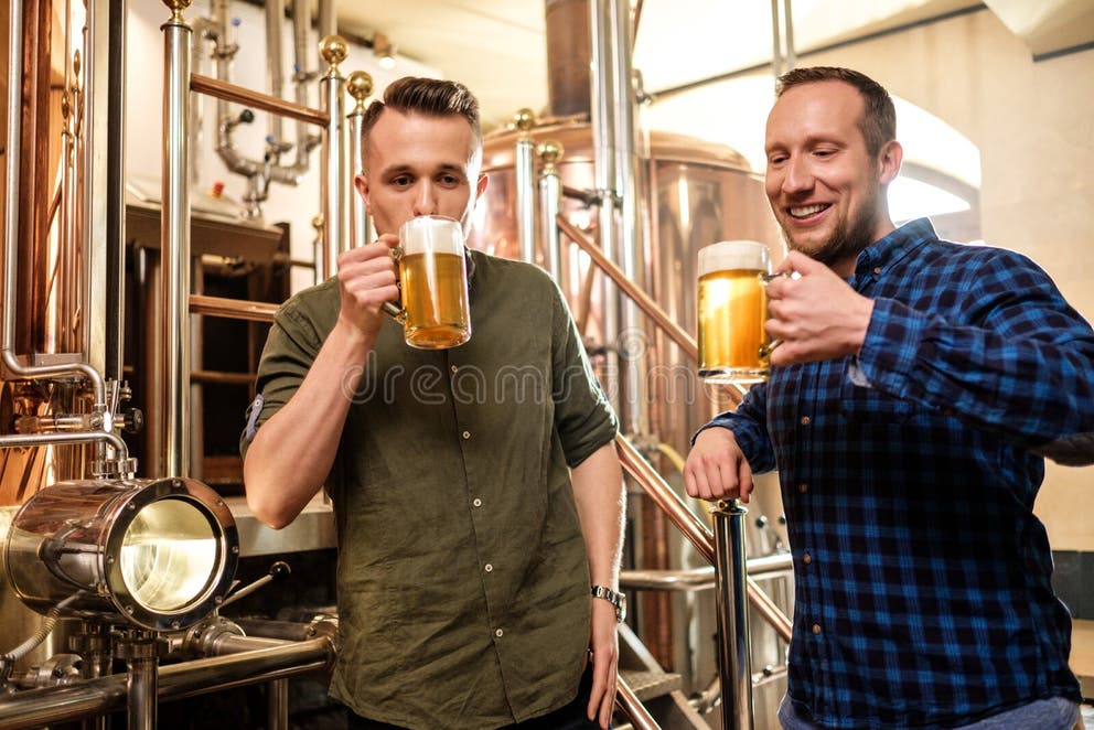 Two Men Tasting Fresh Beer in a Brewery Stock Photo - Image of brewery ...