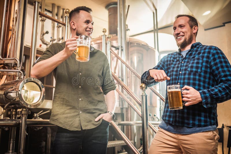 Two Men Tasting Fresh Beer in a Brewery Stock Image - Image of brewing ...