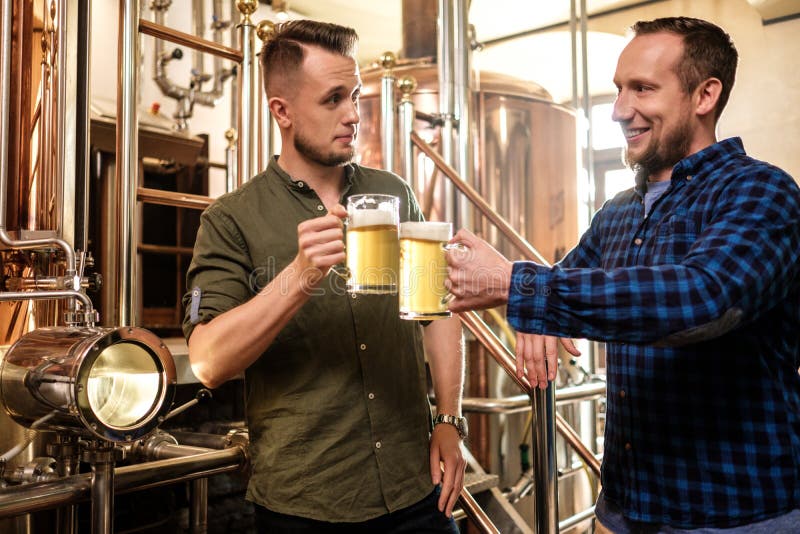 Two Men Tasting Fresh Beer in a Brewery Stock Photo - Image of ...