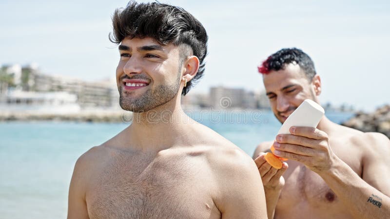Two Men Tourist Couple Applying Sunscreen Lotion at Beach Stock Image ...