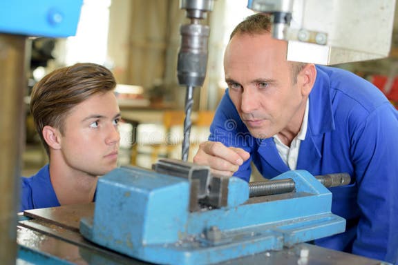 Two men using bench drill stock image. Image of male - 128022481