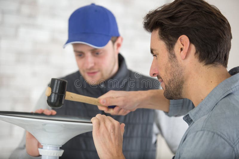 Two Men Using Hammer on Beach Stock Image - Image of installation, sofa: 335182439