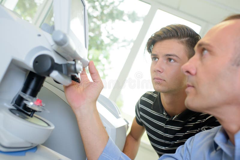 Two Men Using Magnifying Equipment Stock Image - Image of optician ...