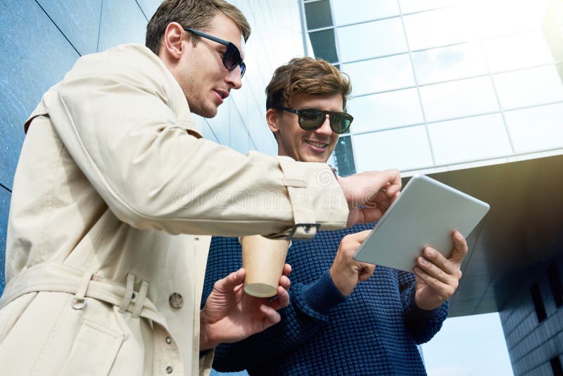 Two Men Using Tablet in Sunlight Stock Image - Image of colleagues ...