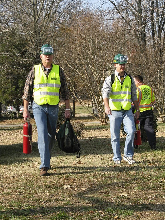 Two Men Walking with Fire Extinguisher in Their Hands. Editorial ...