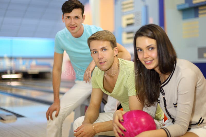 Two Men and Woman Sit in Bowling Club Stock Photo - Image of glamour ...