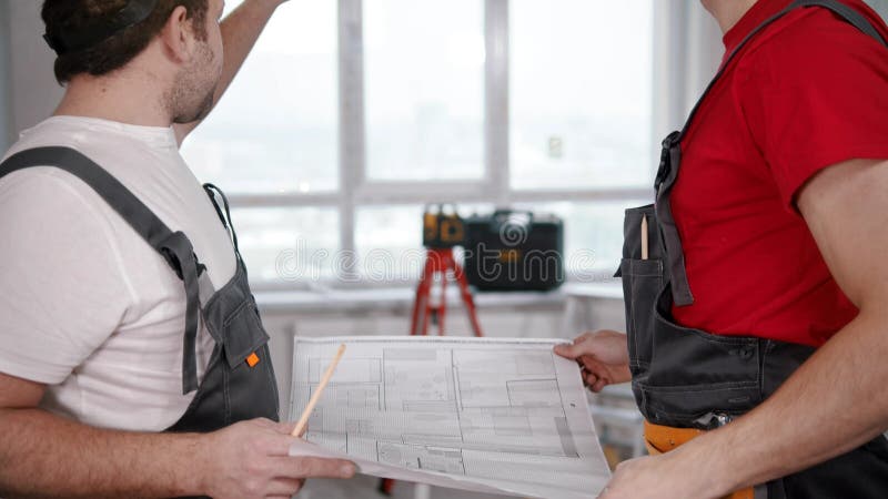 Two Men Workers Looking at the Layout Stock Image - Image of interior ...