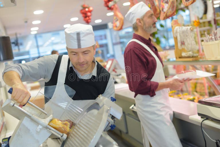 Two Men Working Behind Counter in Delicatessen Stock Photo - Image of ...
