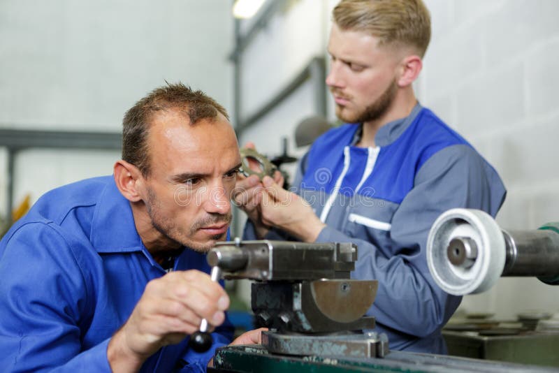 Two Men Working in Engineering Workshop Stock Photo - Image of people ...