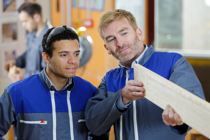 Two men working in factory stock photo. Image of architecture - 246349762