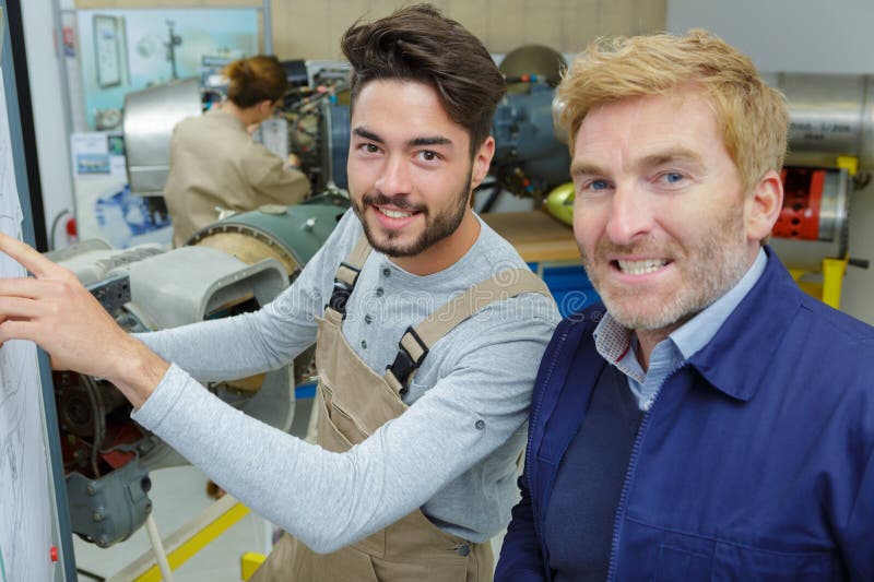 Two men working at factory stock image. Image of valve - 275397429