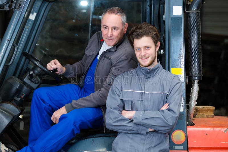 Two men working in factory stock photo. Image of owner - 117253774