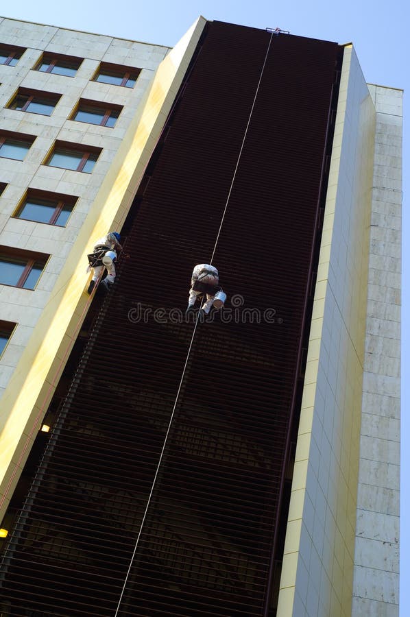 Two men working high stock image. Image of hights, dangle - 36823531