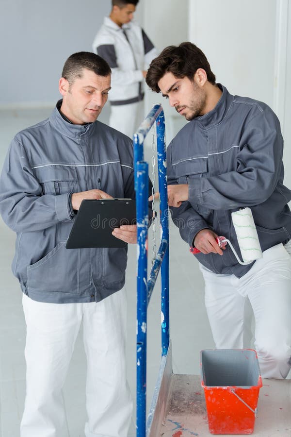 Two men working in house stock image. Image of male - 263614315