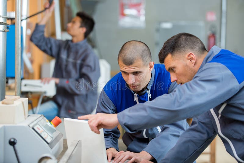 Two Men Working with Machines Stock Photo - Image of precision ...