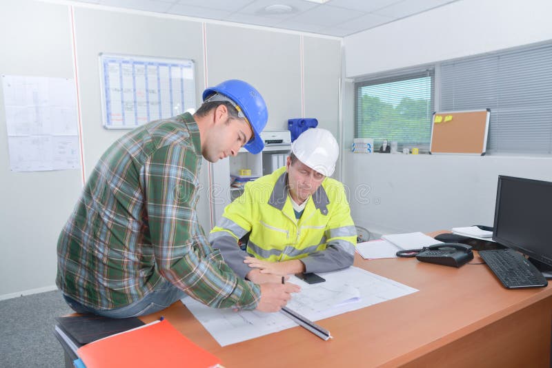 Two Men Working on Scale Drawings One Sat on Table Stock Photo - Image ...
