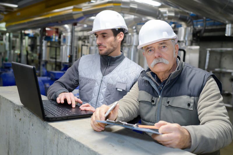 Two men working together stock image. Image of modern - 197409973