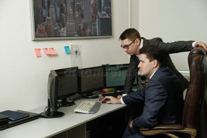Two Men Working Together for the Computers in the Office Engaged in ...