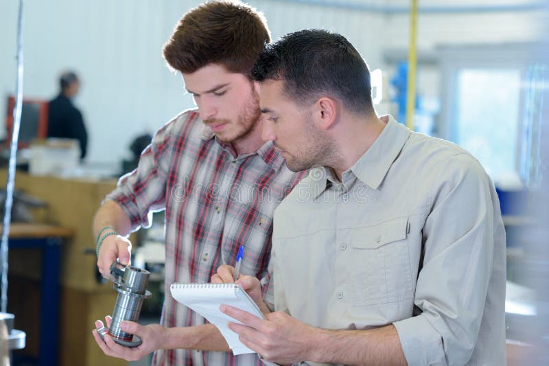 Two Men Working Together in Workshop Stock Image - Image of machine ...