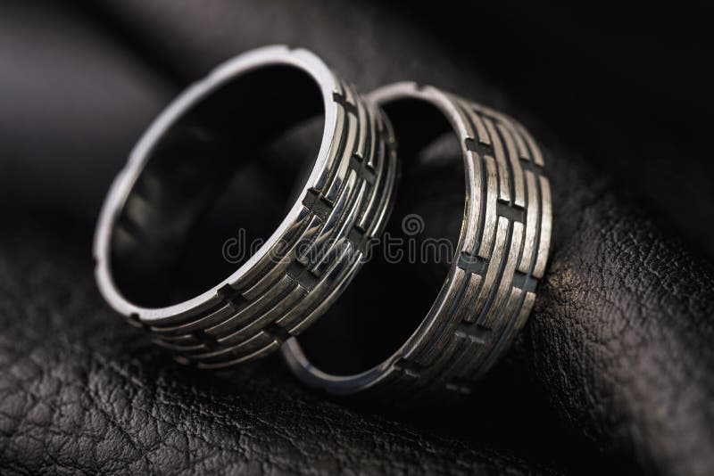 Two Mens Rings with Different Processing on a Stand Made of Black ...