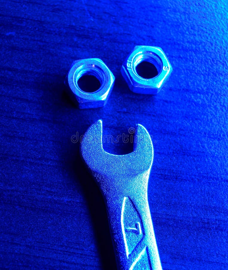 Two Metal Nuts and a Spanner Which Creates a Small Funny Smile Face ...