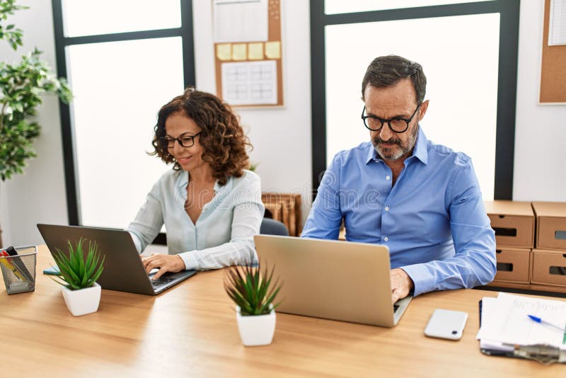 Two Middle Age Business Workers Concentrated Working at the Office ...