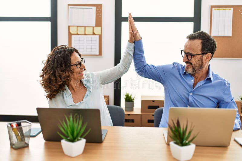 Two Middle Age Business Workers Smiling Happy and High Five at the ...