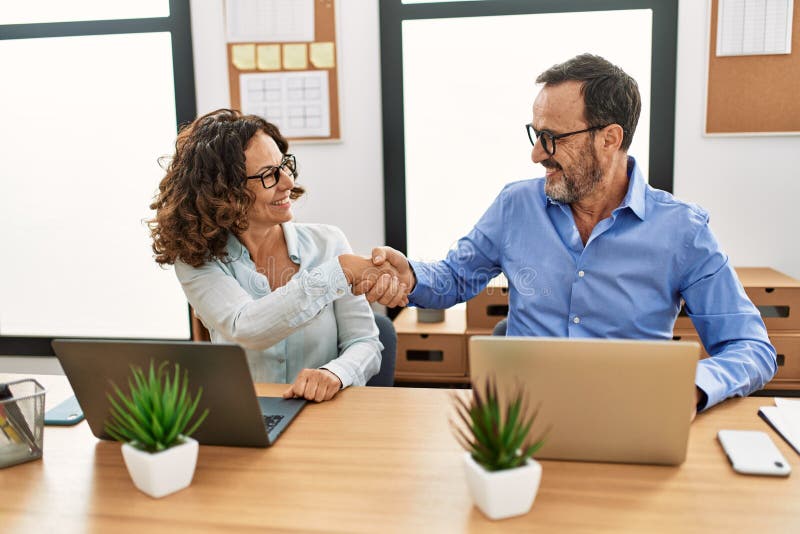 Two Middle Age Business Workers Smiling Happy and Shaking Hands at the ...