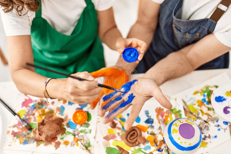 Two Middle Age Student Smiling Happy Painting Hands at Art Studio Stock ...