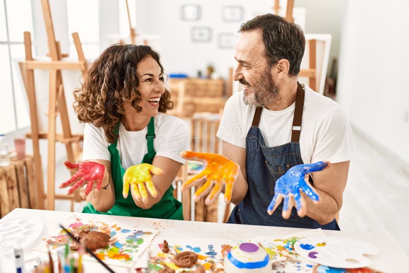 Two Middle Age Student Smiling Happy Showing Paint Hands at Art Studio ...