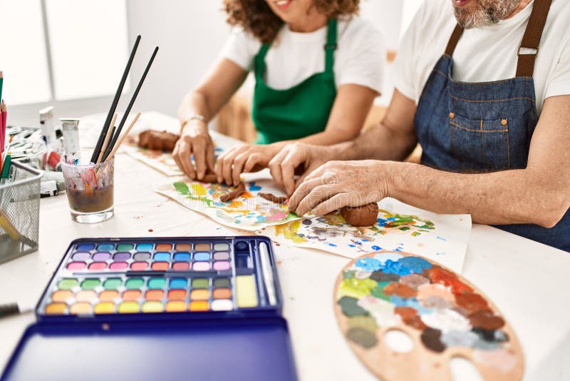 Two Middle Age Students Smiling Happy Modeling Clay Sitting on the ...