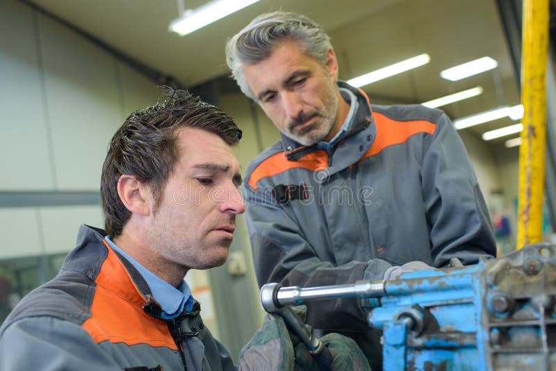 Two Middle Aged Mechanics at Work Stock Photo - Image of colleagues ...