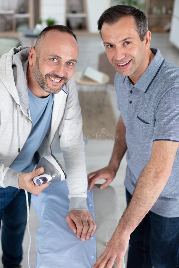 Two Middle Aged Men Stood by Ironing Board Stock Photo - Image of lgbt ...